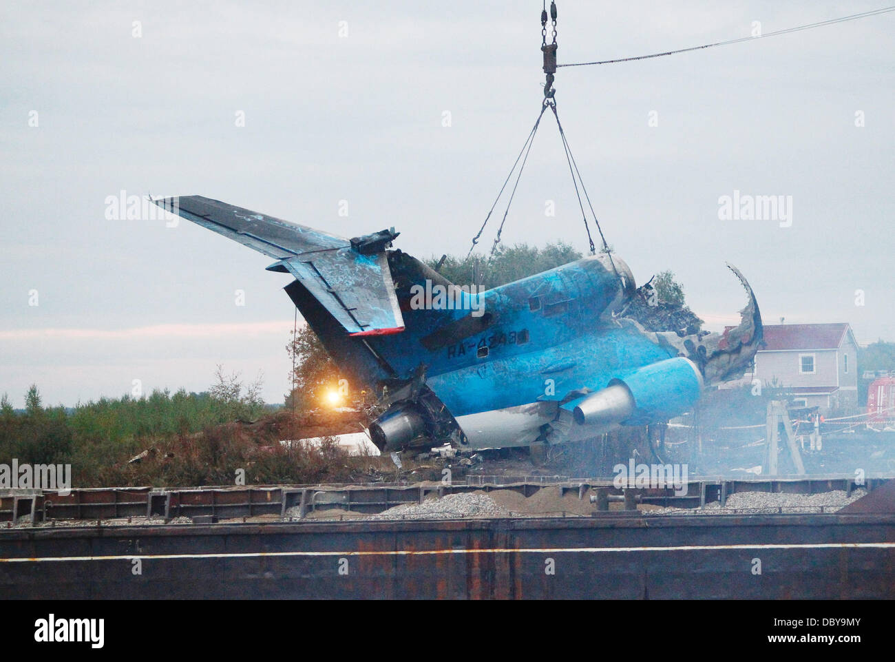 Investigators inspect the debris of a plane at the crash site near the ...