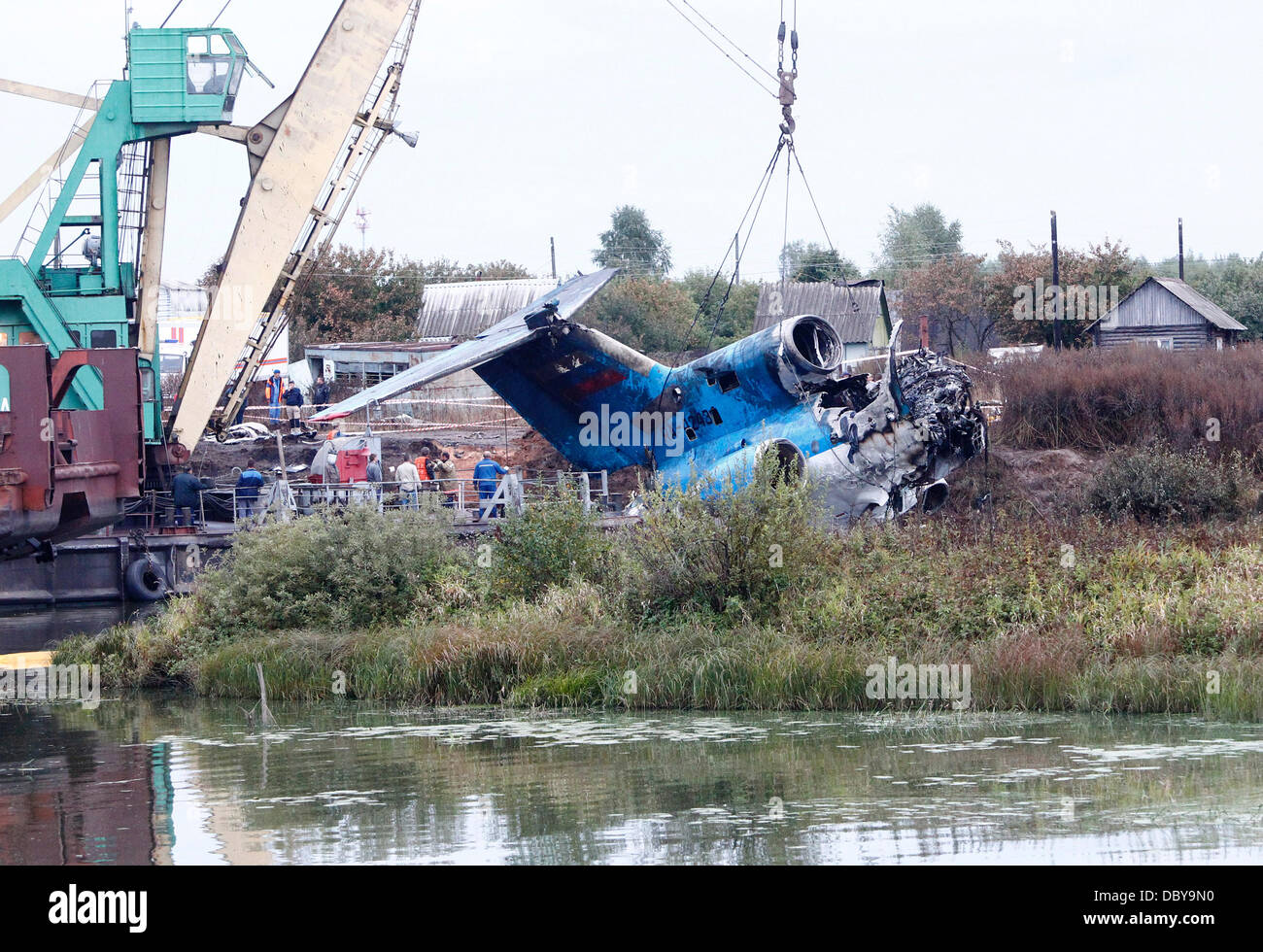 Investigators inspect the debris of a plane at the crash site near the ...