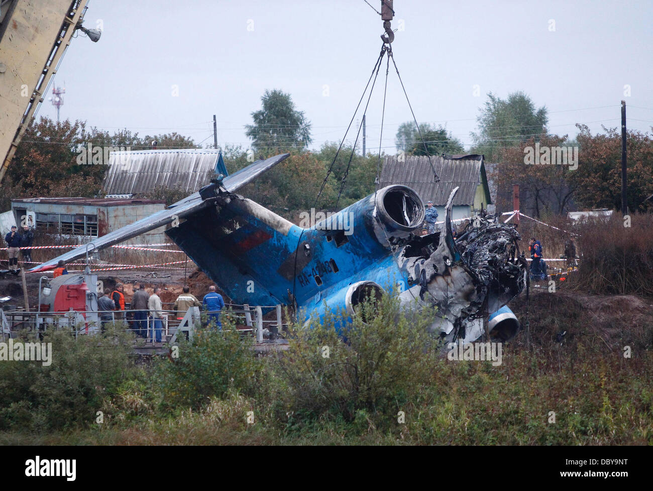 Investigators inspect the debris of a plane at the crash site near the ...