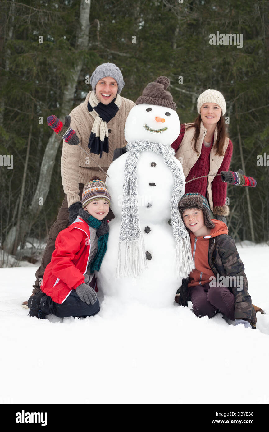 Family with snowman hi-res stock photography and images - Alamy