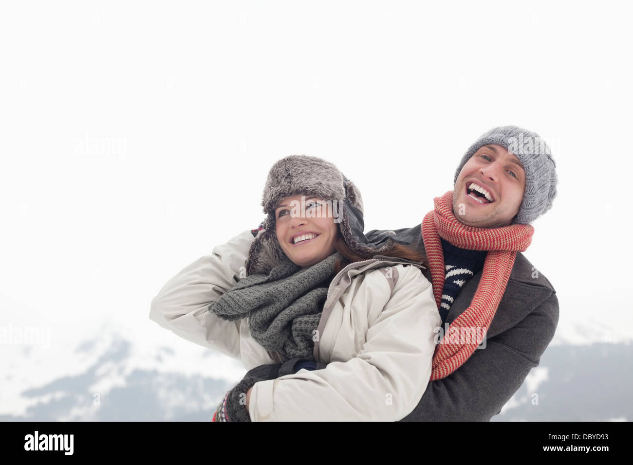 Happy couple hugging with mountain in background Stock Photo - Alamy