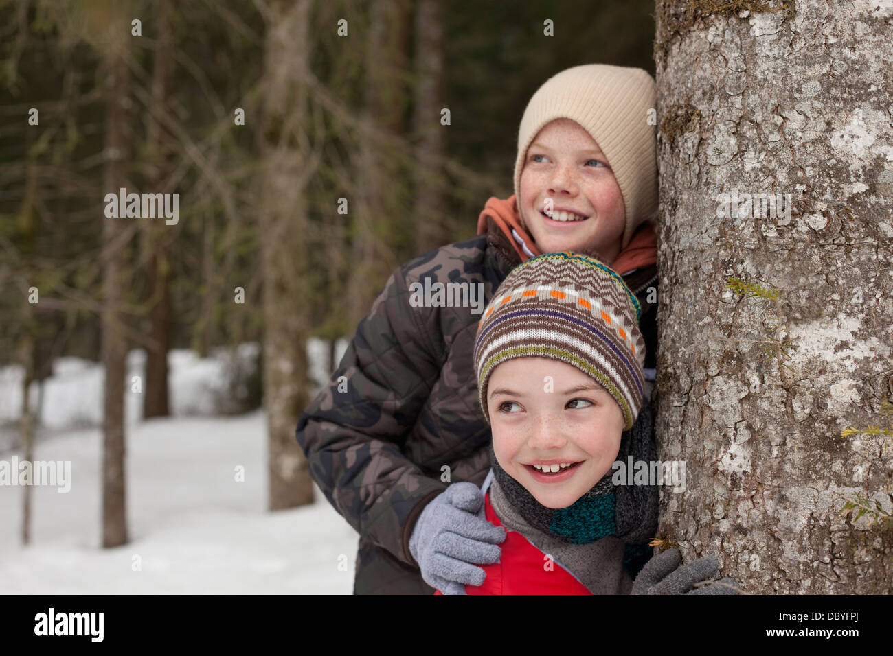 Boy leaning against tree hi-res stock photography and images - Alamy