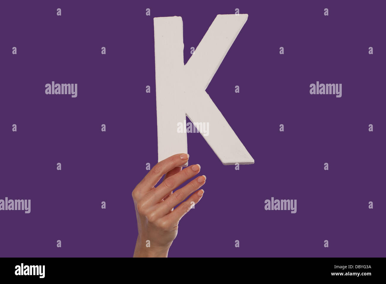 Female hand holding up the letter K from the bottom Stock Photo - Alamy
