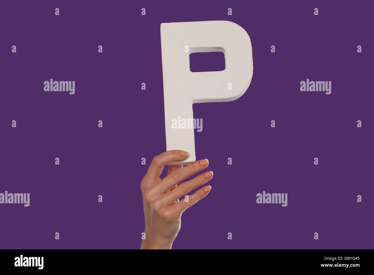 Female hand holding up the letter P from the bottom Stock Photo - Alamy