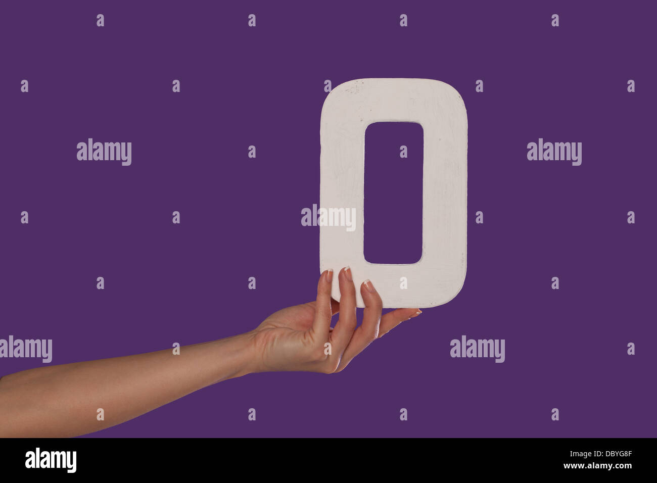 Female hand holding up the number 0 from the left Stock Photo - Alamy