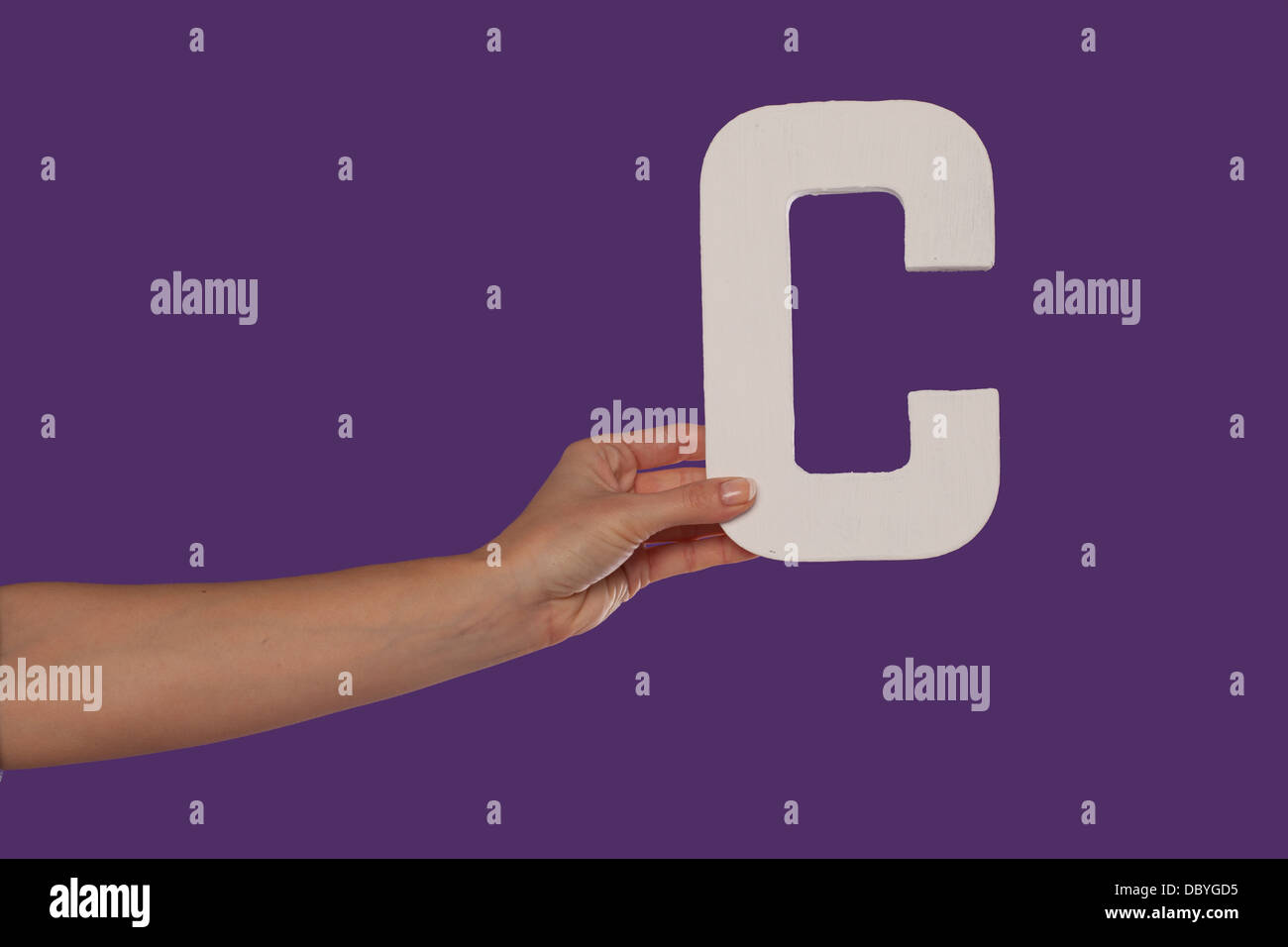 Female hand holding up the letter C from the left Stock Photo - Alamy