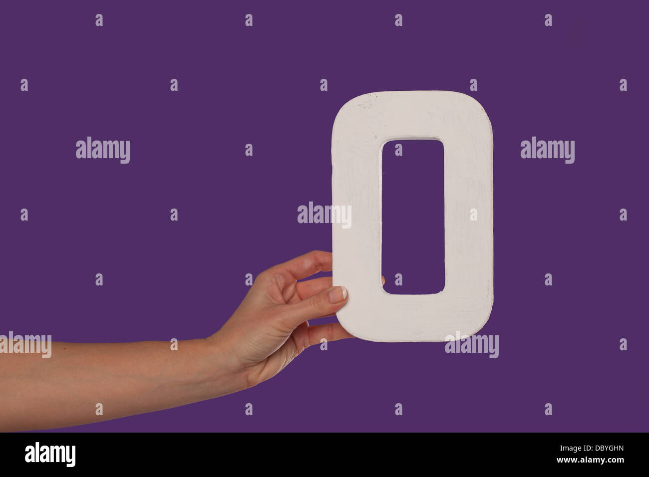 Female hand holding up the letter O from the left Stock Photo - Alamy