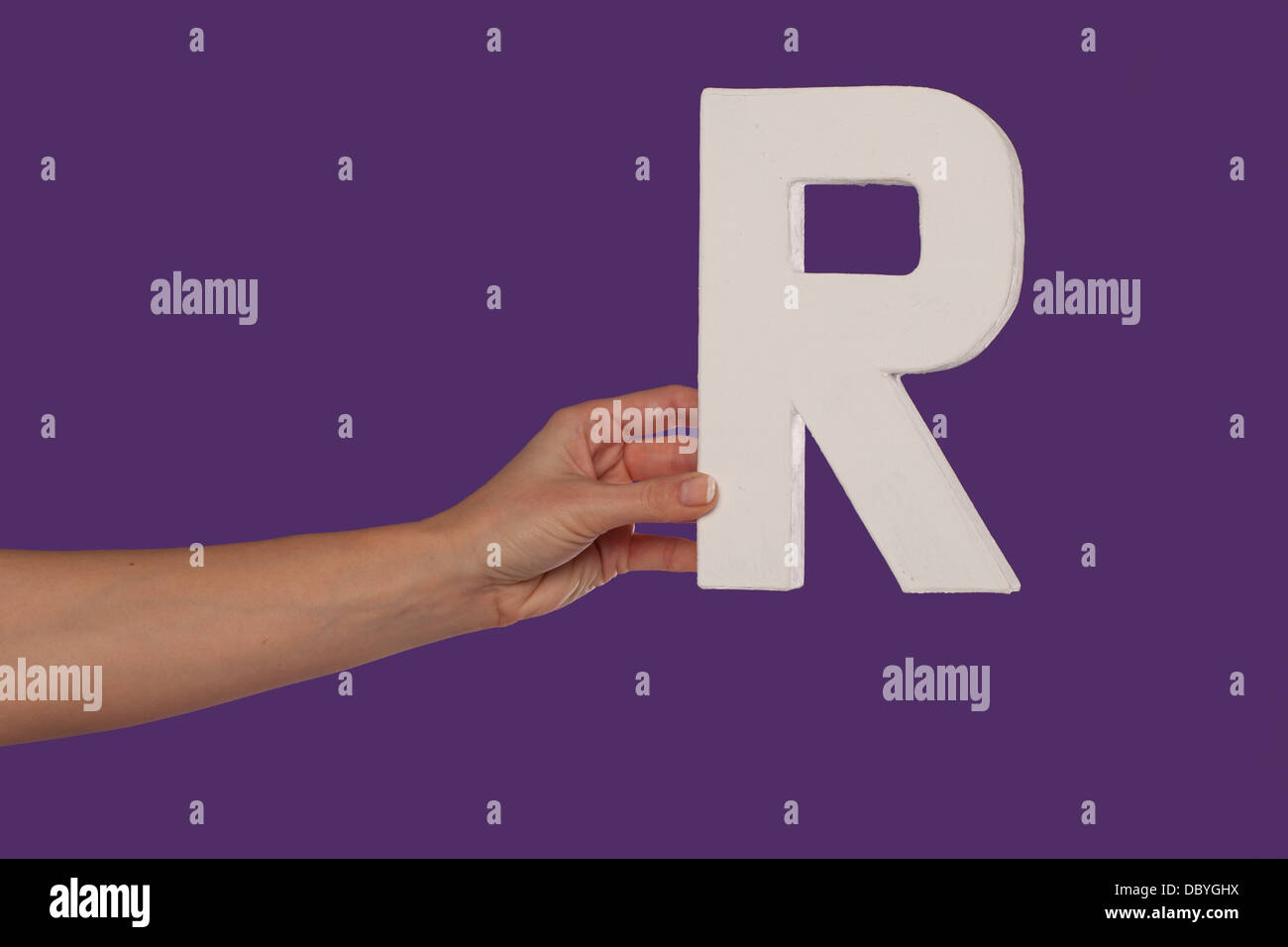Female hand holding up the letter R from the left Stock Photo - Alamy