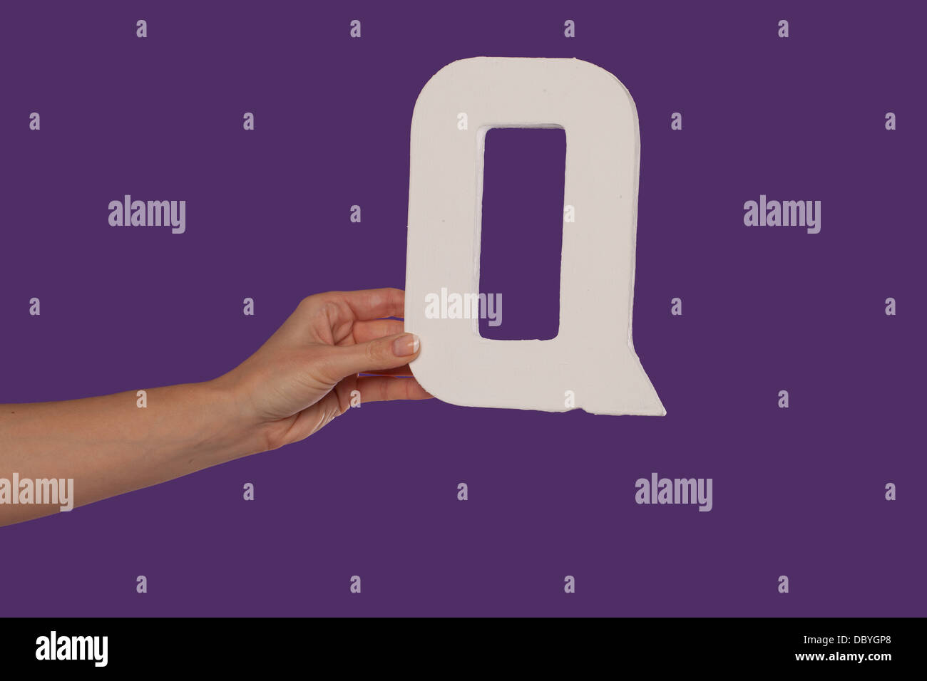 Female hand holding up the letter Q from the left Stock Photo - Alamy