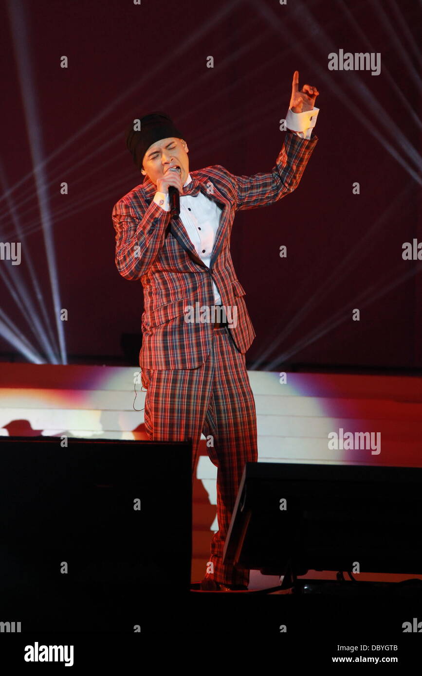 Guangzhou, China. 4th Aug, 2013. Singer Justin Lo holds his personal ...