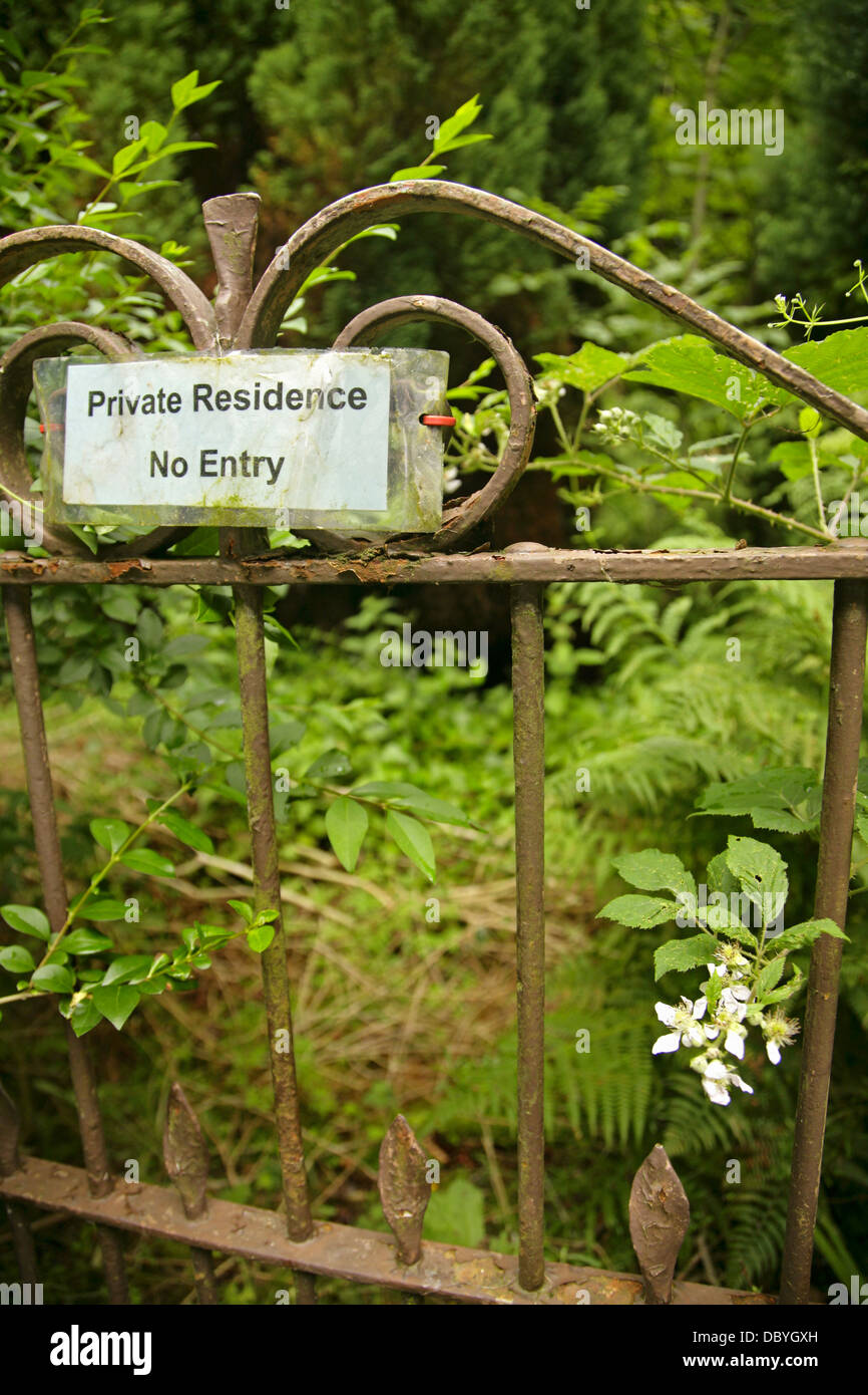 No Entry sign on old wrought iron front gate of very overgrown garden ...