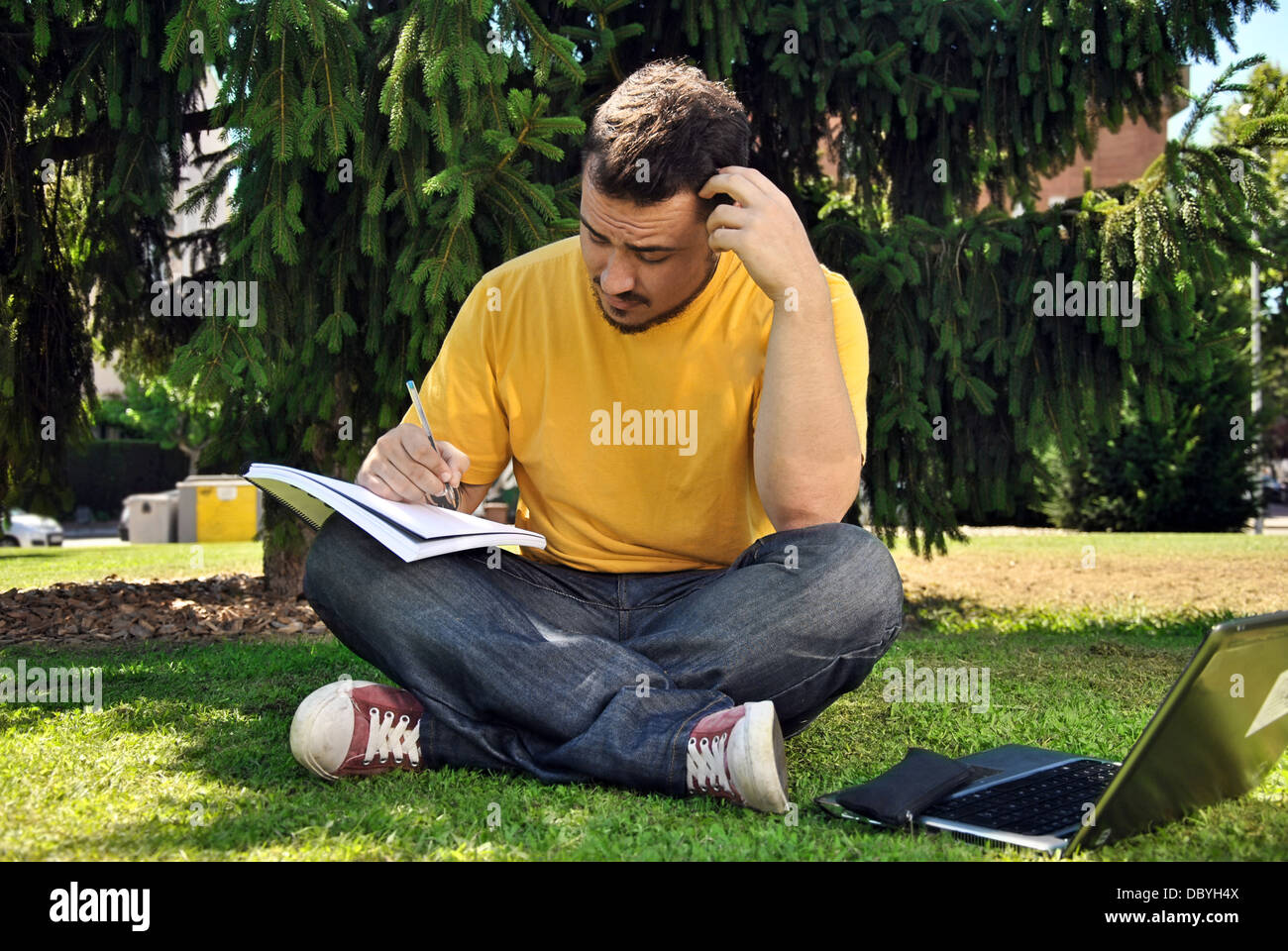 college student lying on the grass in the sun Stock Photo - Alamy