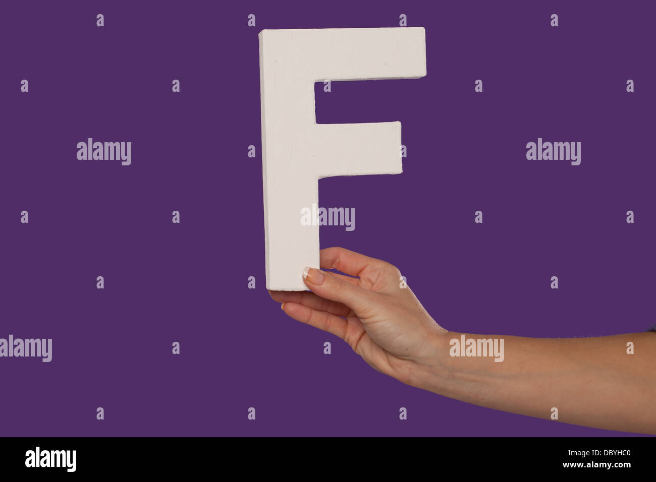 Female hand holding up the letter F from the right Stock Photo - Alamy