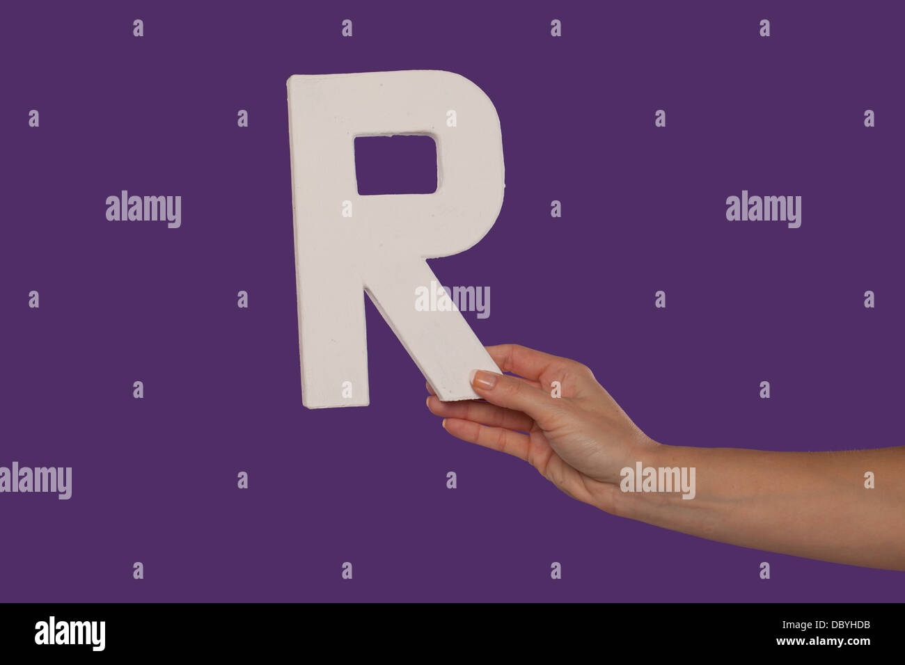 Female hand holding up the letter R from the right Stock Photo - Alamy