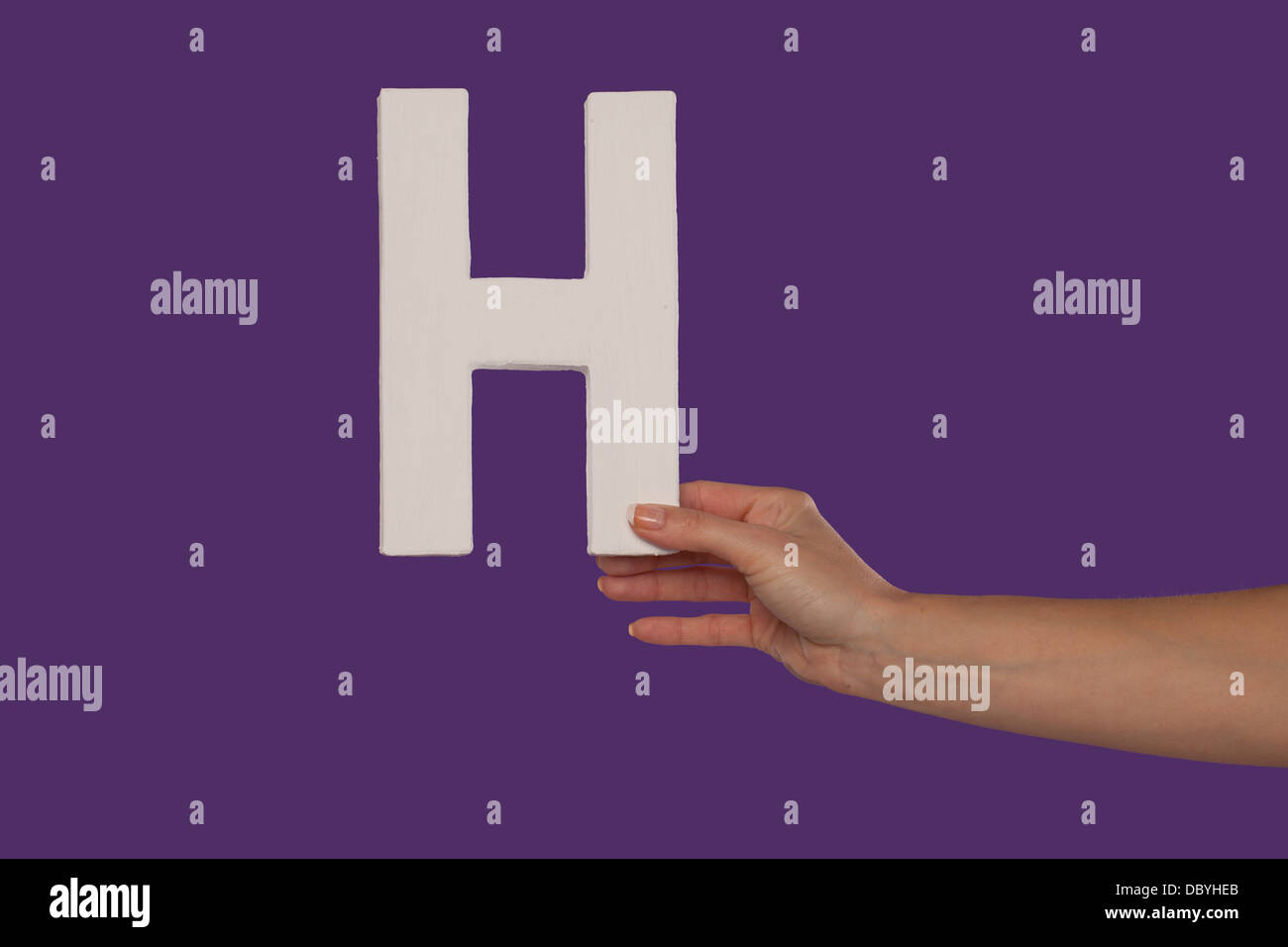 Female hand holding up the letter H from the right Stock Photo - Alamy