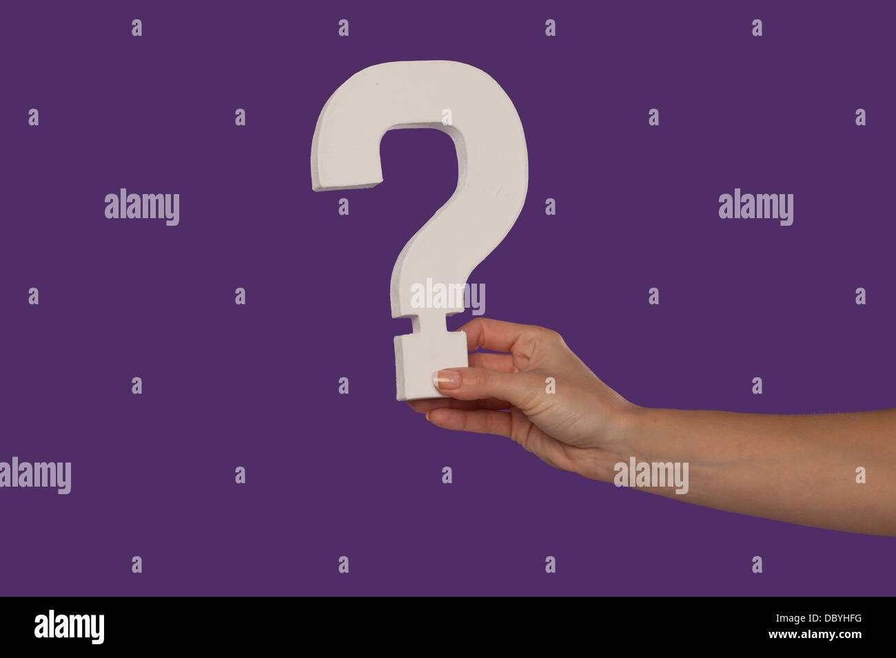 Female hand holding up a question mark from the right Stock Photo - Alamy