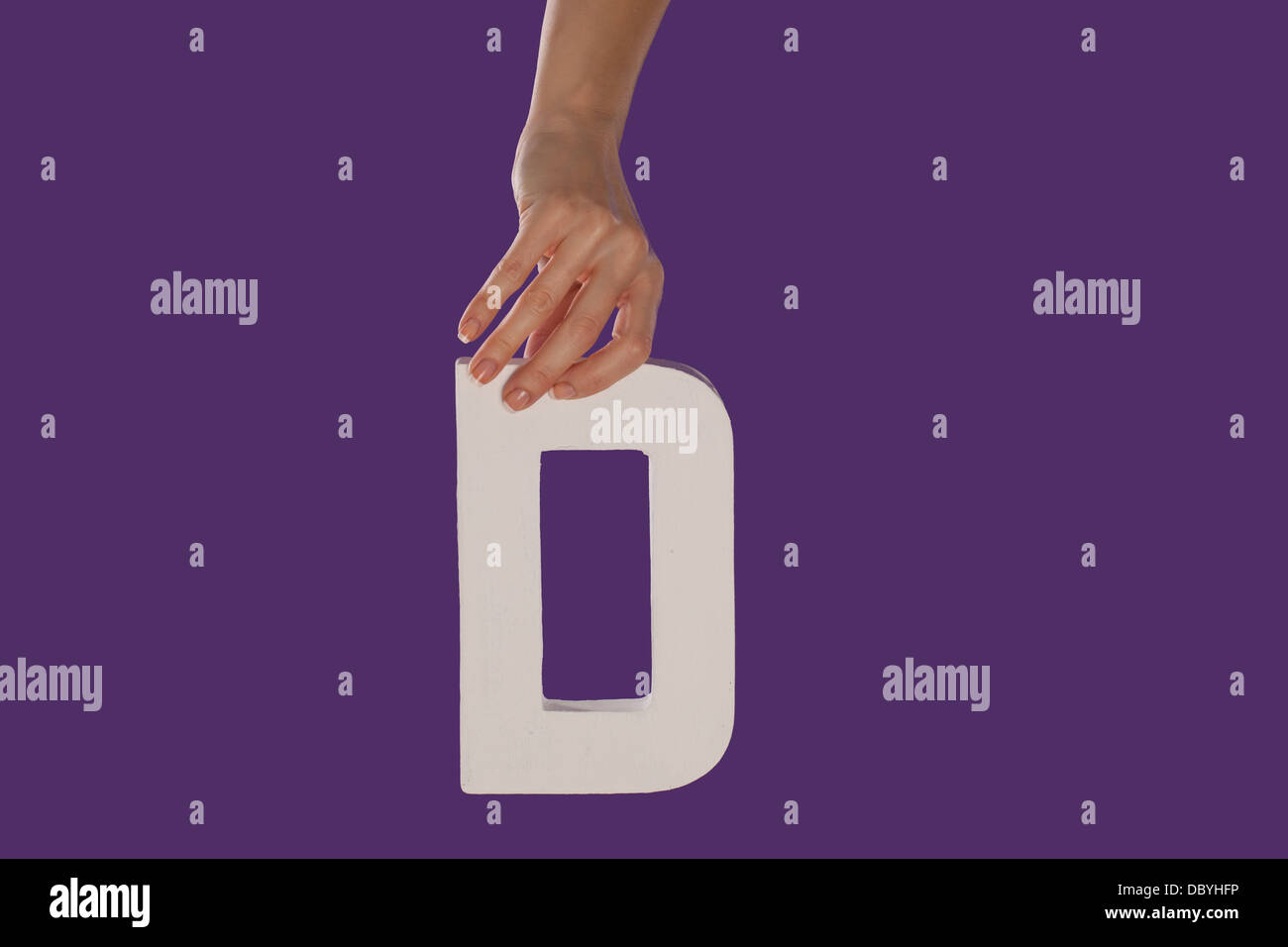 Female hand holding up the letter D from top Stock Photo - Alamy
