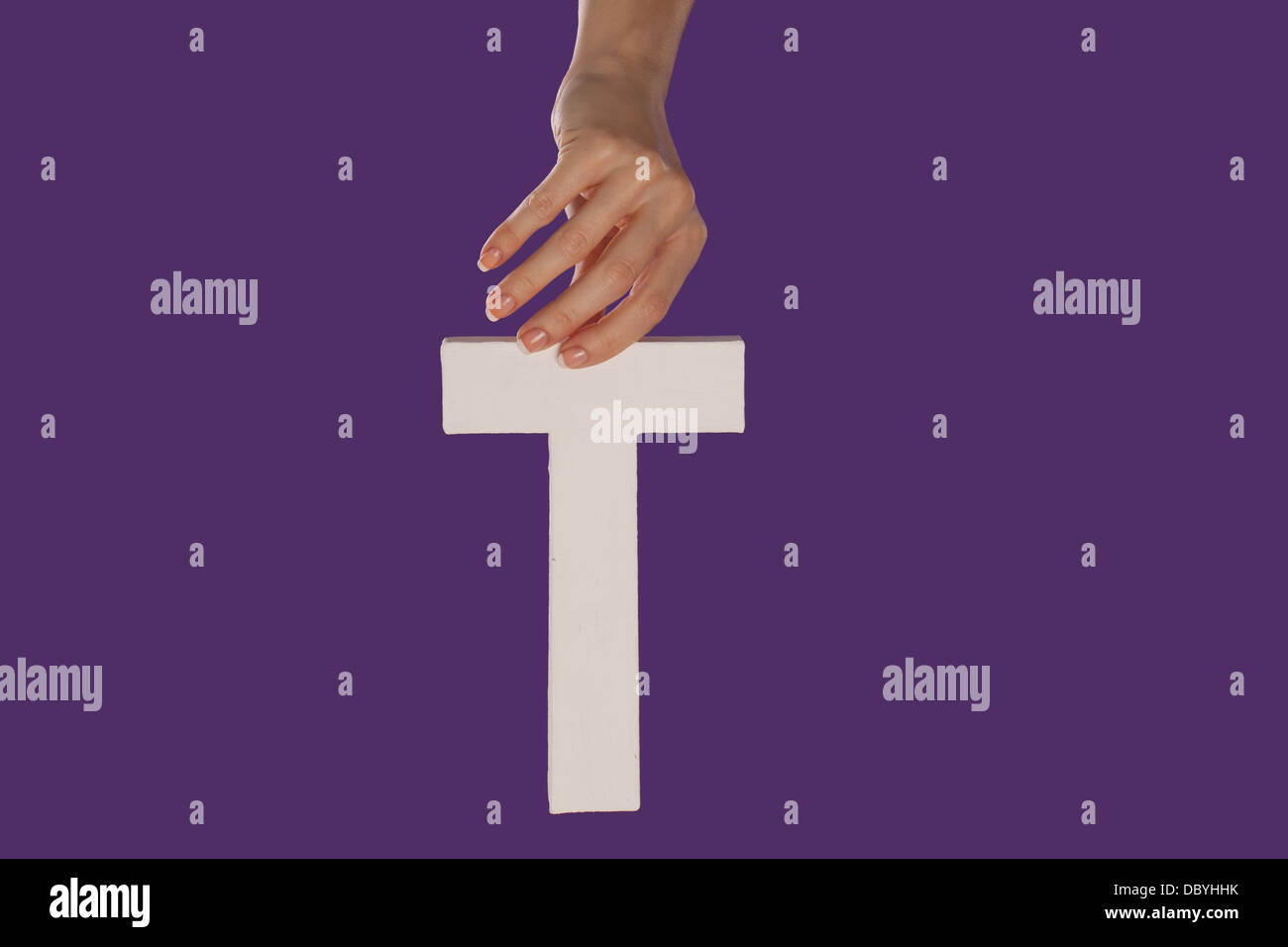 Female hand holding up the letter T from top Stock Photo - Alamy