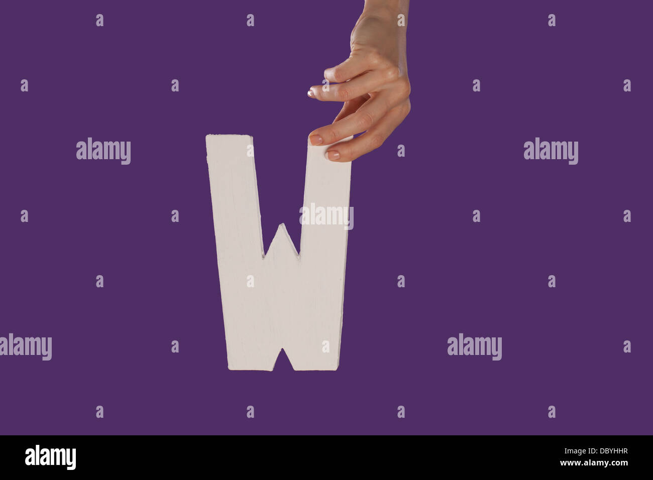 Female hand holding up the letter W from top Stock Photo - Alamy