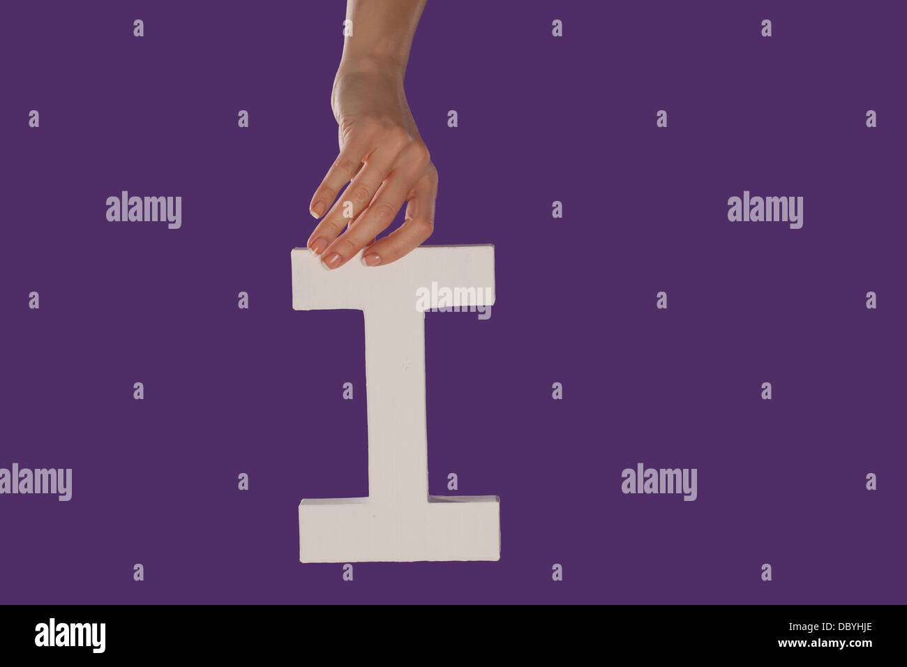Female hand holding up the letter I from top Stock Photo - Alamy