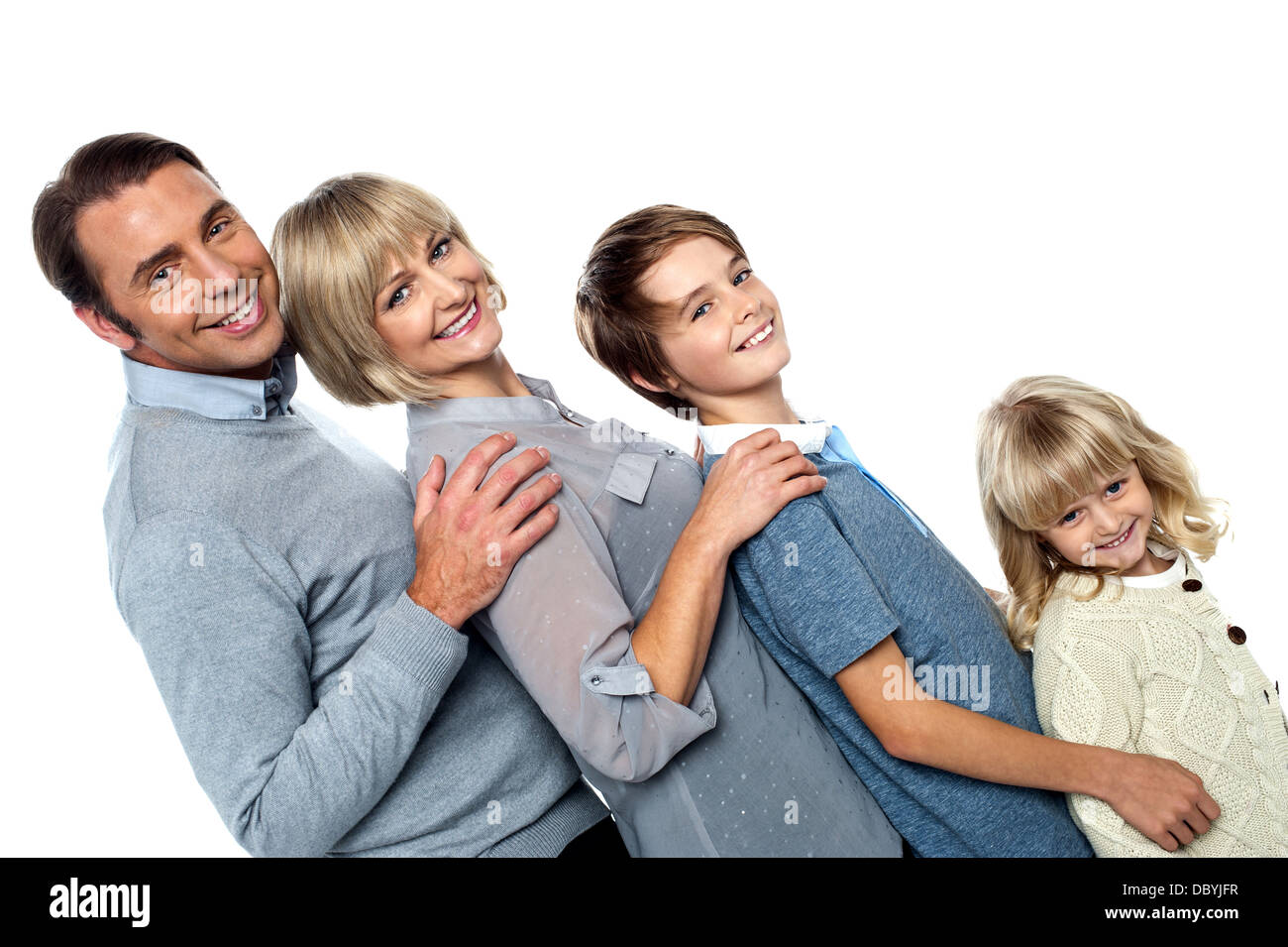 Cheerful family of four leaning backwards Stock Photo - Alamy