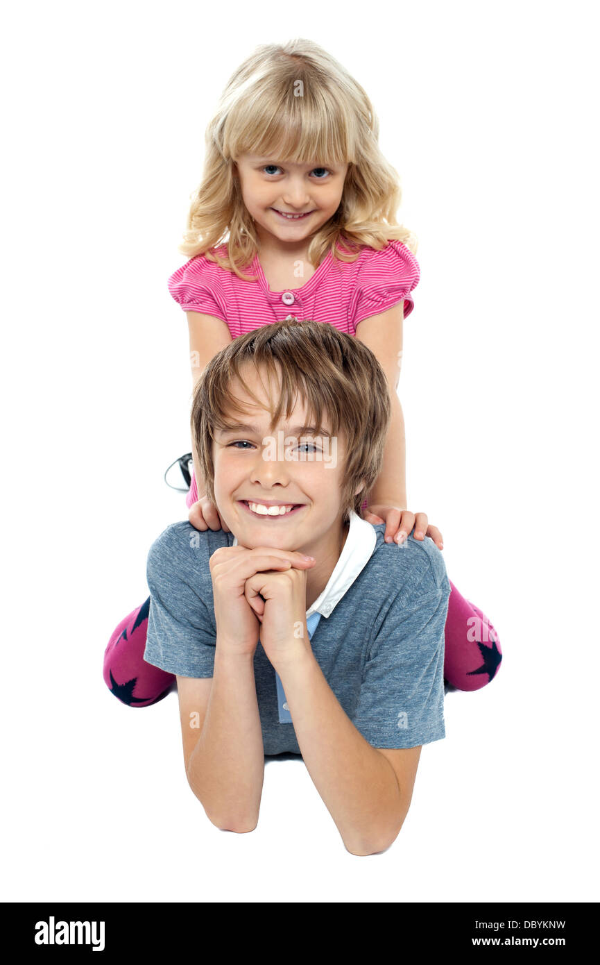 Adorable sister sitting on her brothers back Stock Photo - Alamy