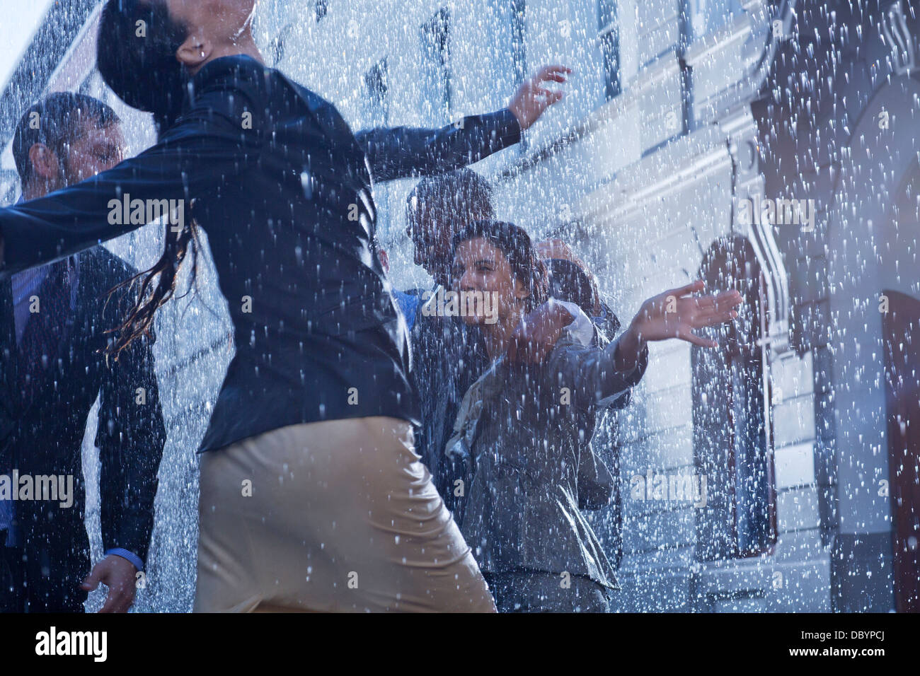 Business people dancing in rain Stock Photo - Alamy