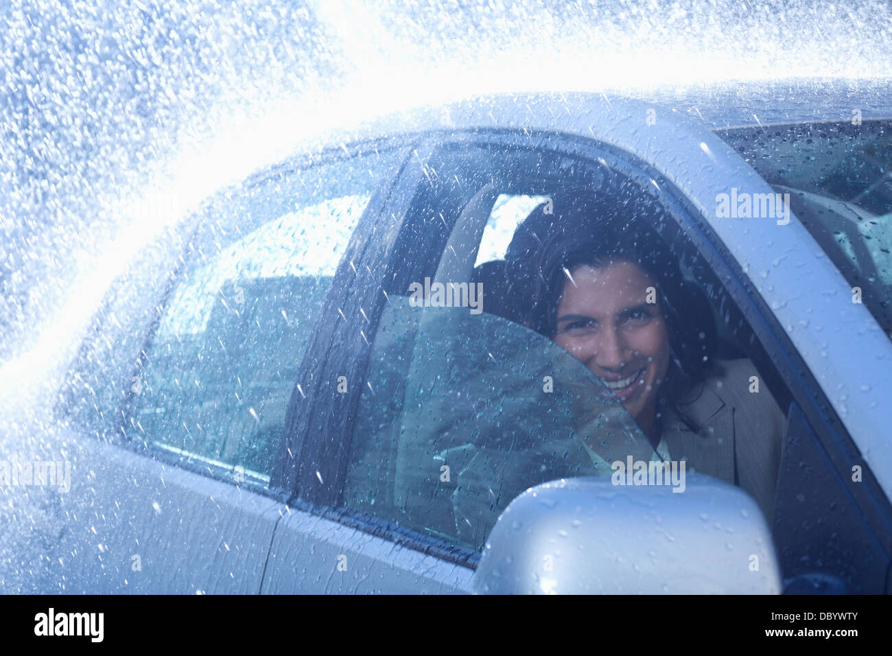 Portrait of smiling businesswoman inside car in rain Stock Photo - Alamy