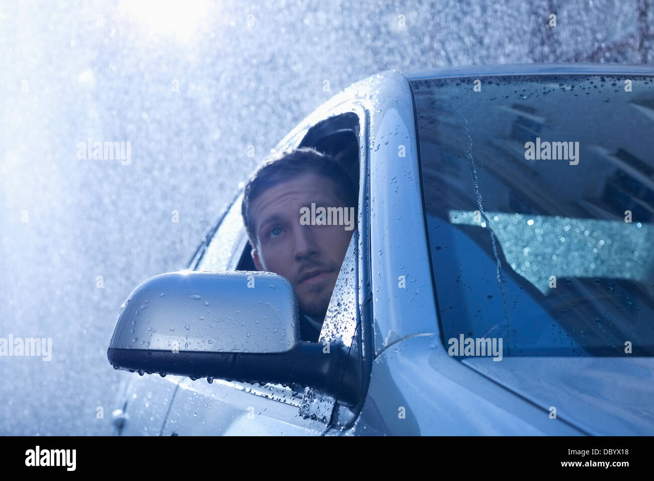 Businessman in car looking out window at rain Stock Photo - Alamy