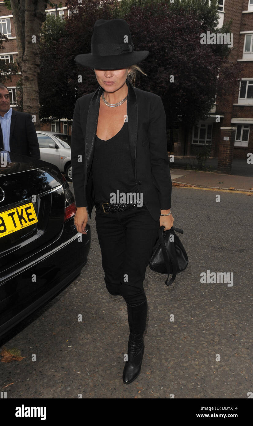 Kate Moss hides her face under a black trilby, as she visits a friedns ...