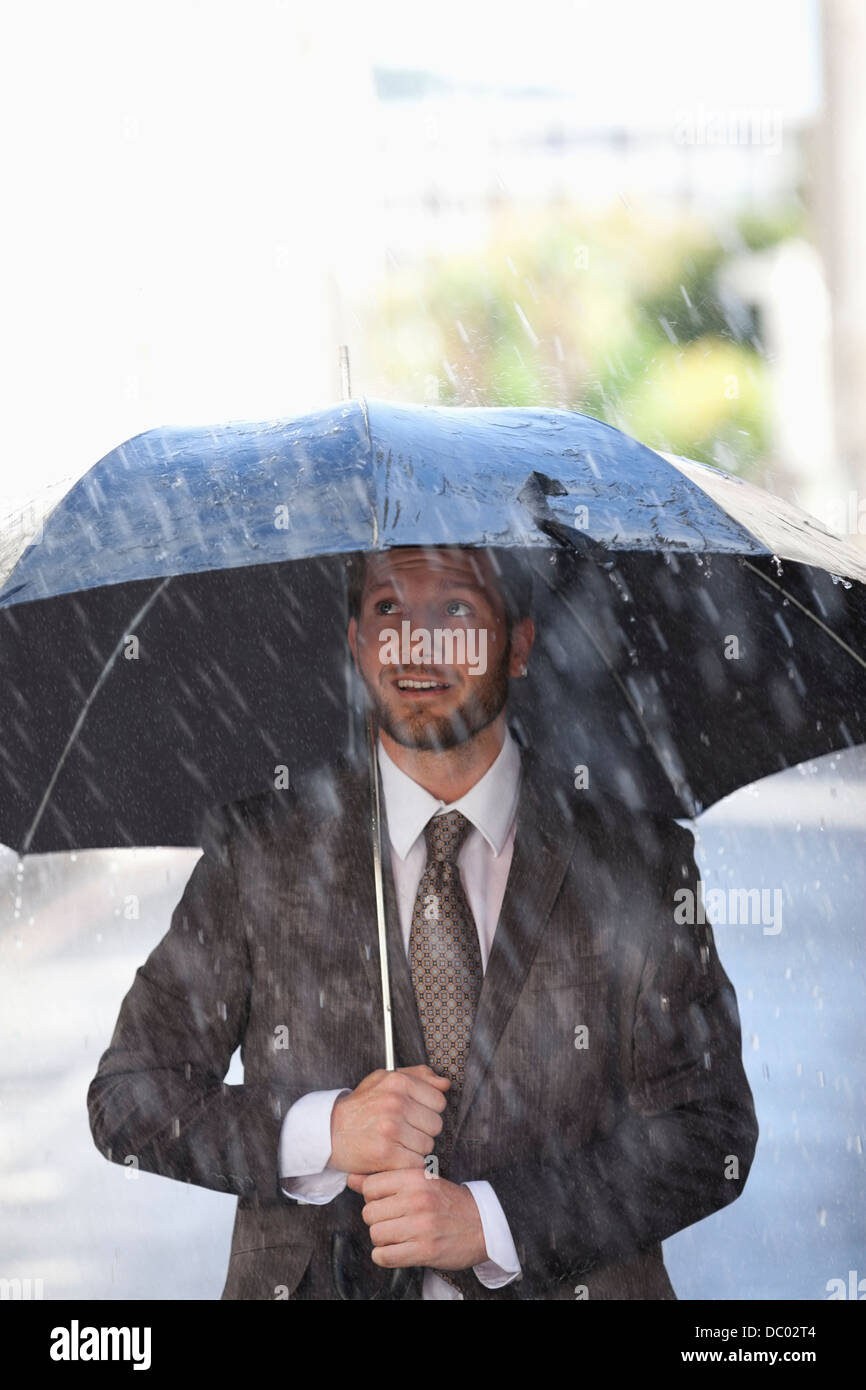 Umbrella on road under rain hi-res stock photography and images - Alamy