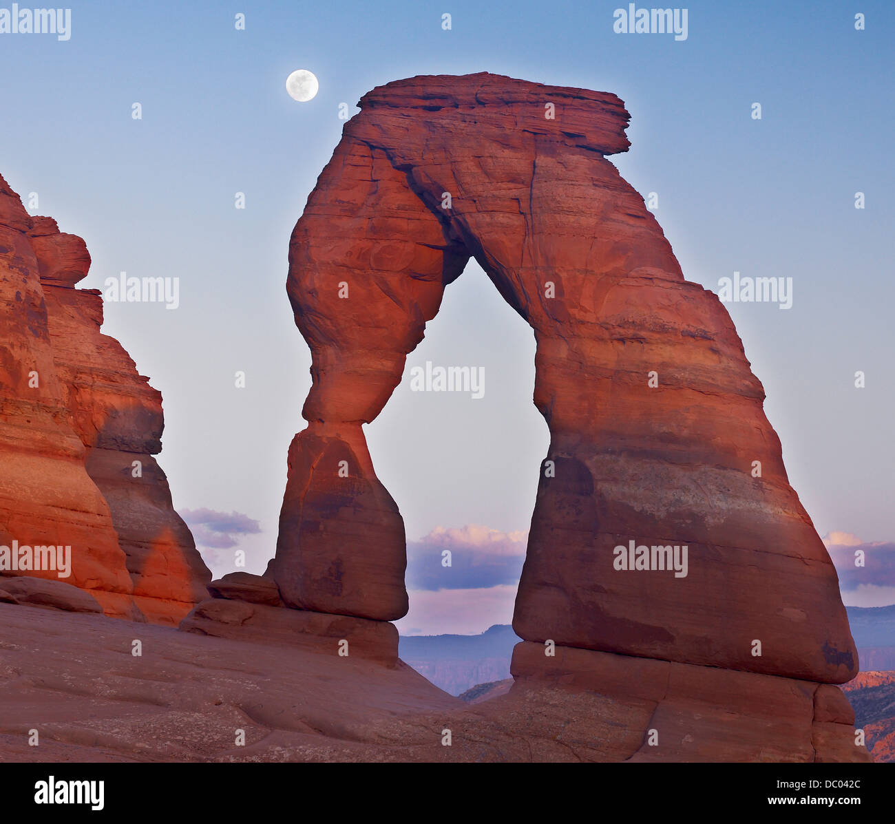 Delicate Arch and full moon at sunset Stock Photo - Alamy