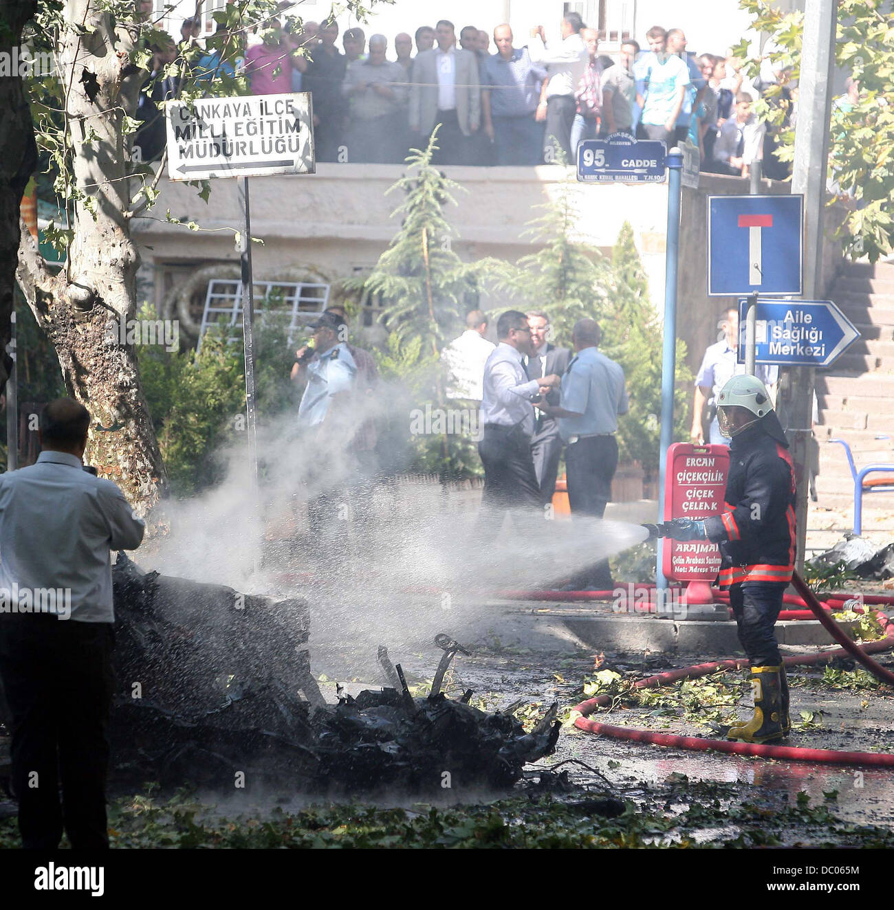 Turkish police officers, firefighters and forensic experts work the ...