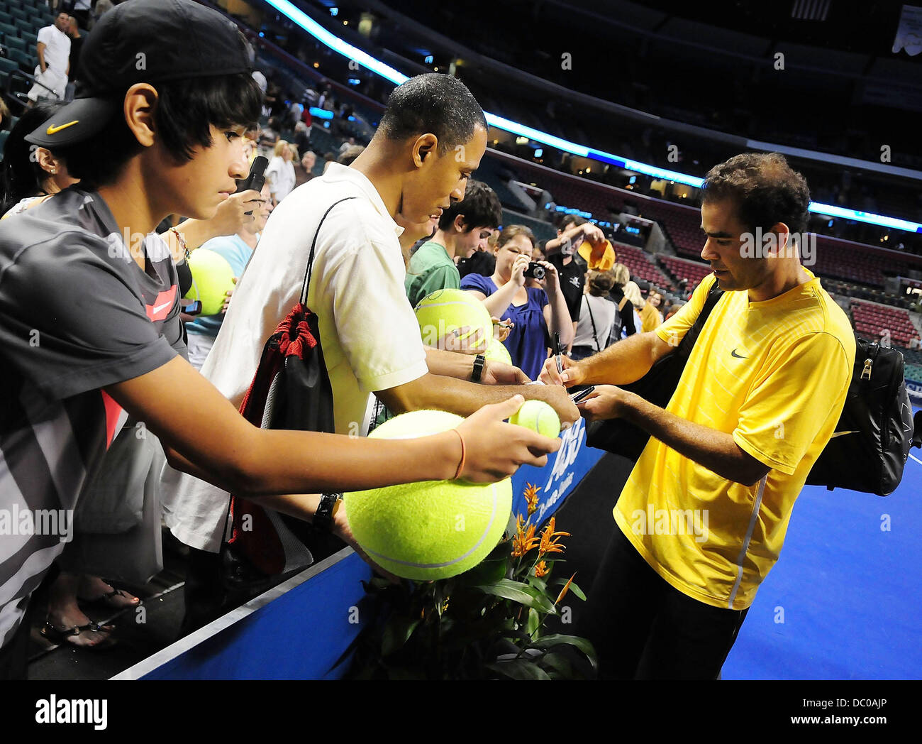 Pete Sampras signing autographs for fans after the championship match ...