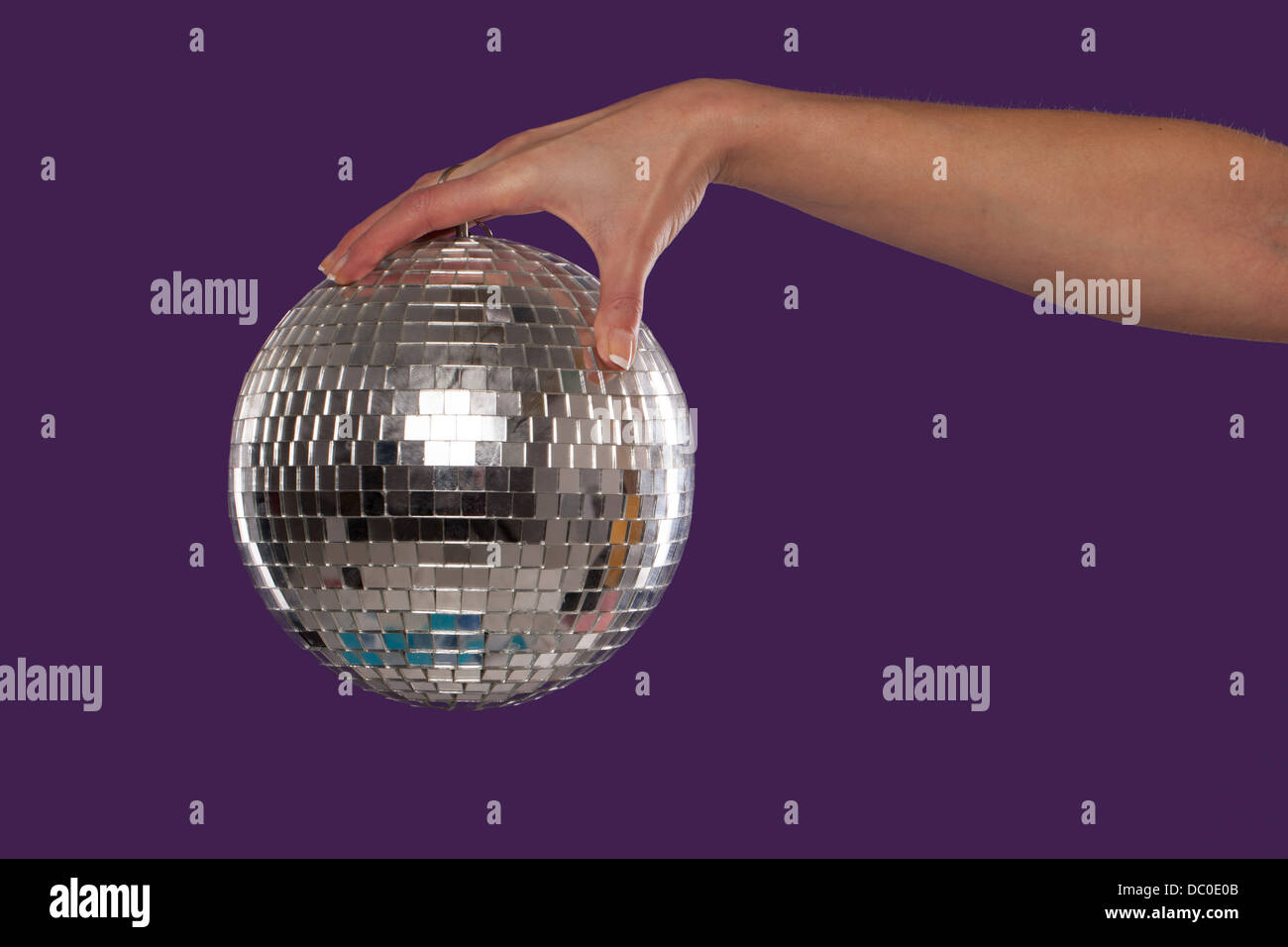 Female hand holding a disco ball Stock Photo - Alamy