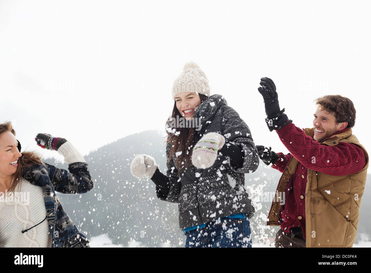 Couple enjoying snowball fight Stock Photo - Alamy