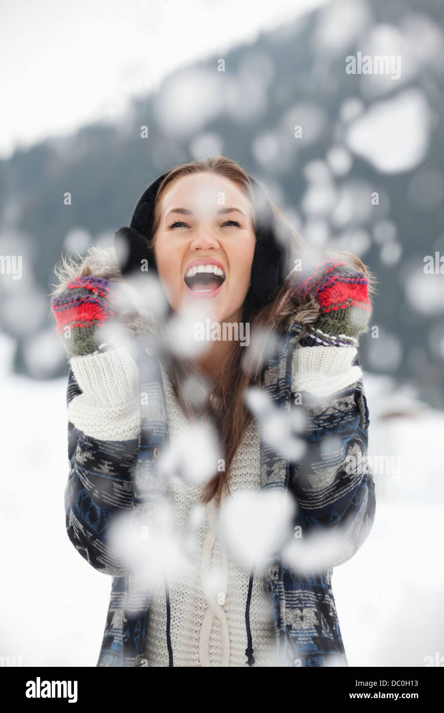 Enthusiastic woman enjoying falling snow Stock Photo - Alamy