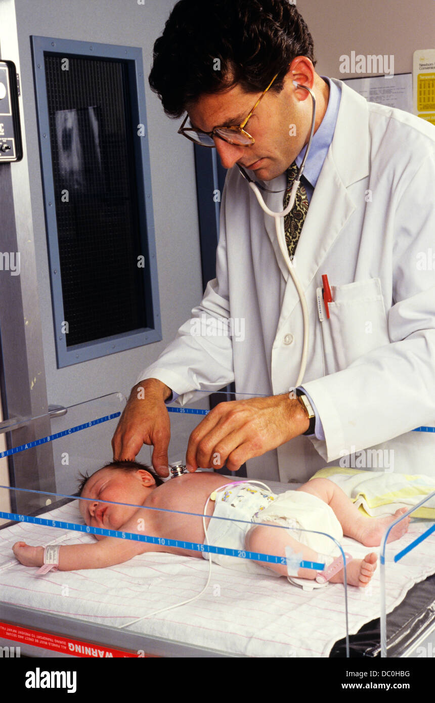 1990s DOCTOR GIVING NEWBORN BABY EXAMINATION IN NURSERY Stock Photo - Alamy