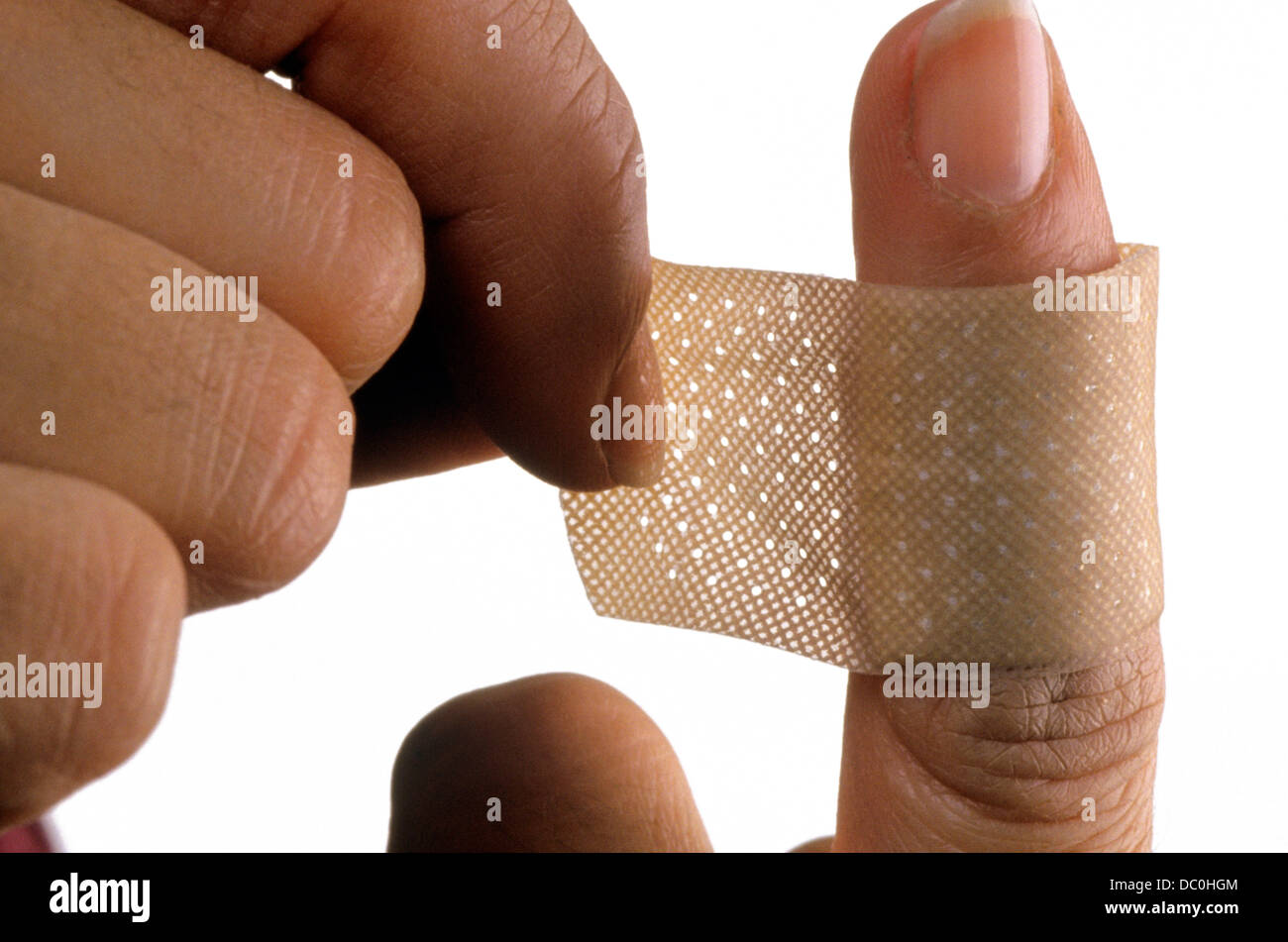 1990s APPLYING FLESH COLORED BAND-AID BANDAGE TO INDEX FINGER Stock ...