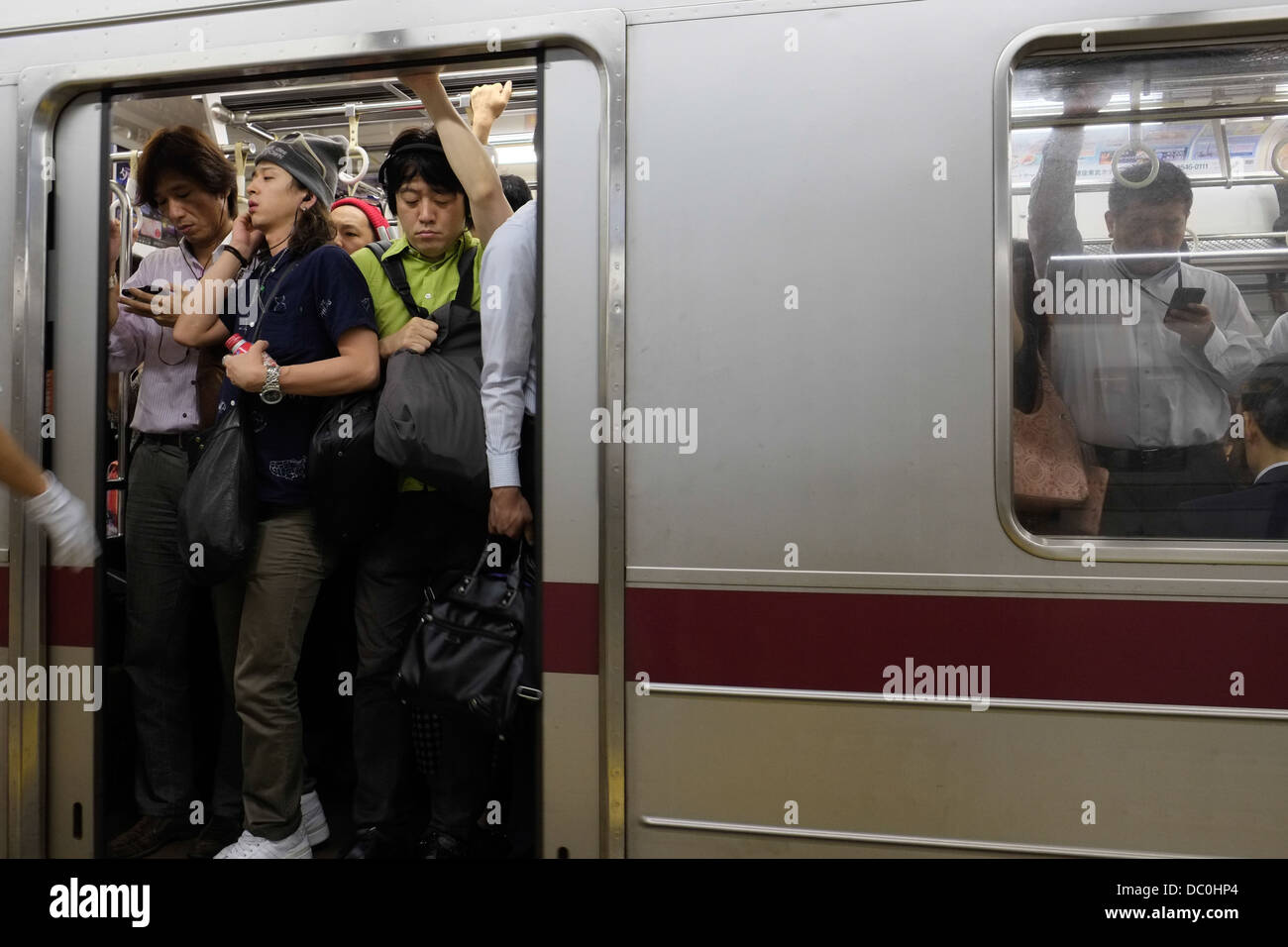 Crowded Japanese subway train Stock Photo - Alamy