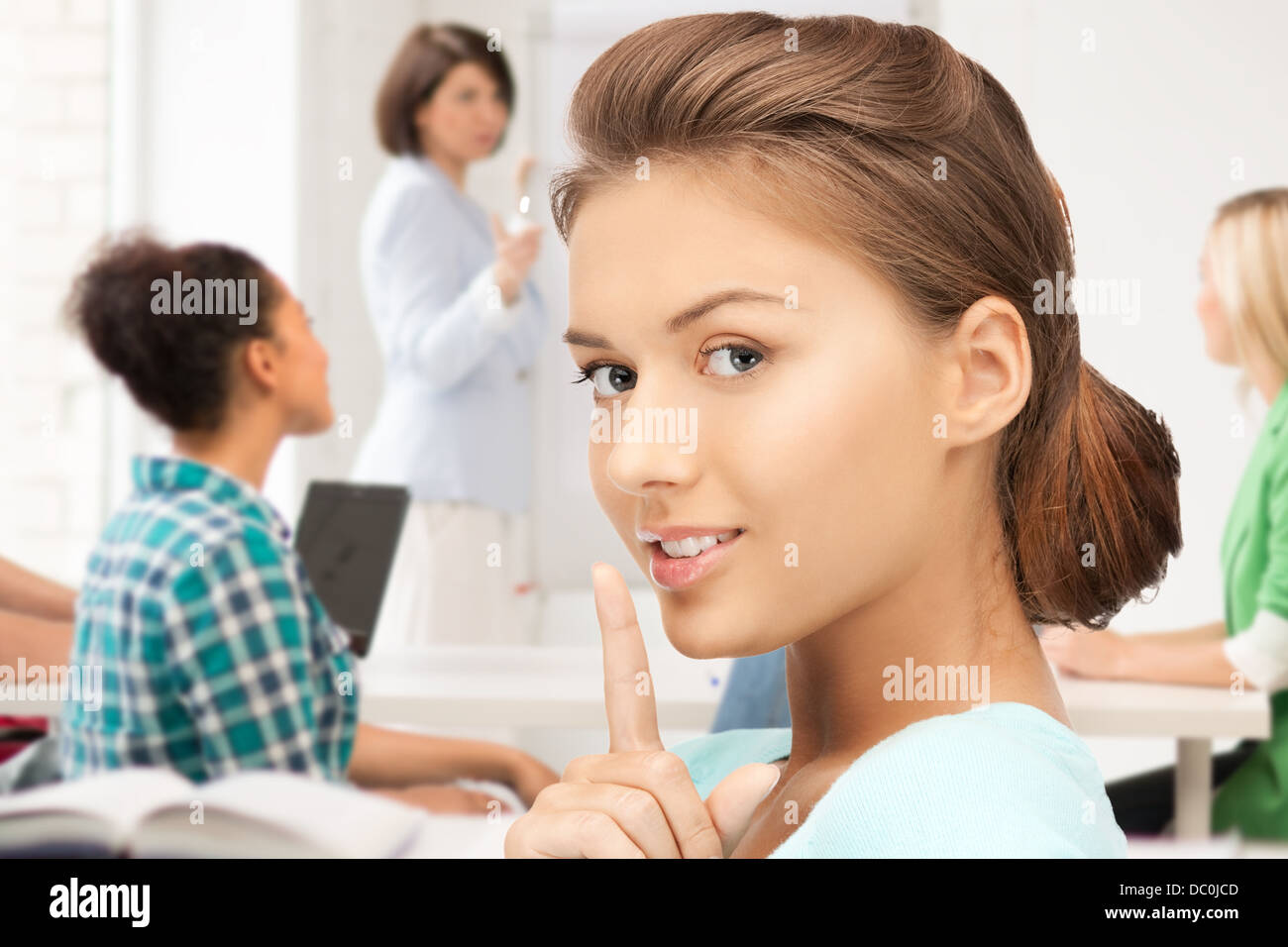 student making hush gesture at school Stock Photo - Alamy