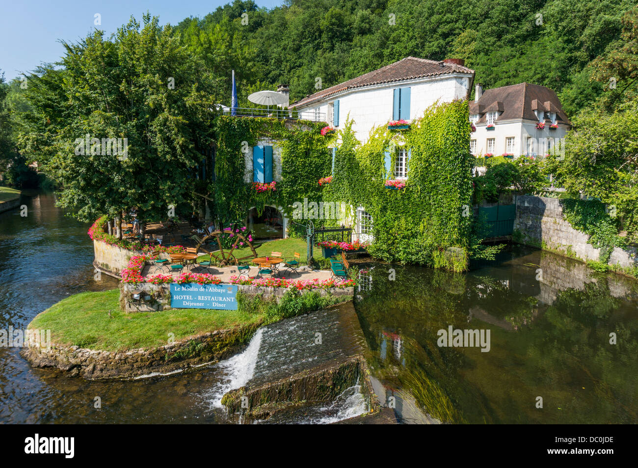 Beautiful scene of the ivy covered Moulin Hotel and the river Dronne ...