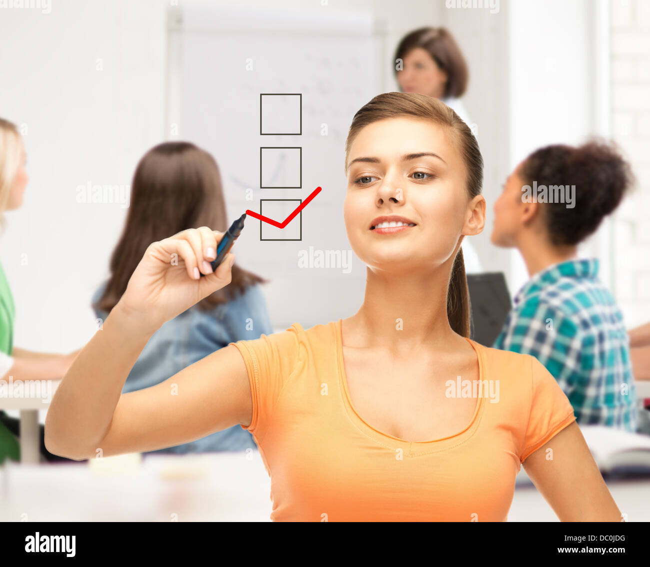 student drawing checkmark on virtual screen Stock Photo - Alamy