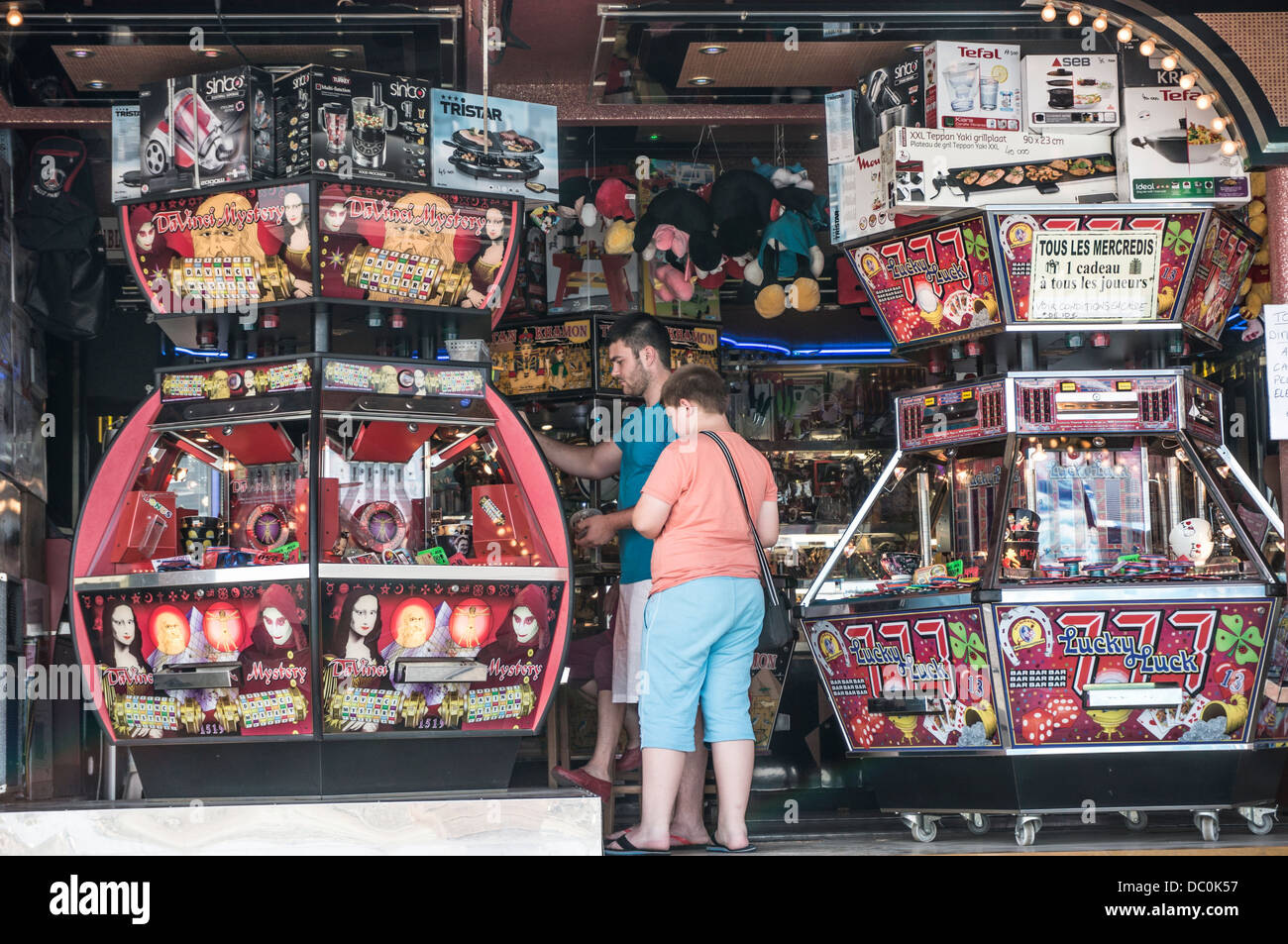 Two people playing at an amusement arcade in the coastal town of Le ...