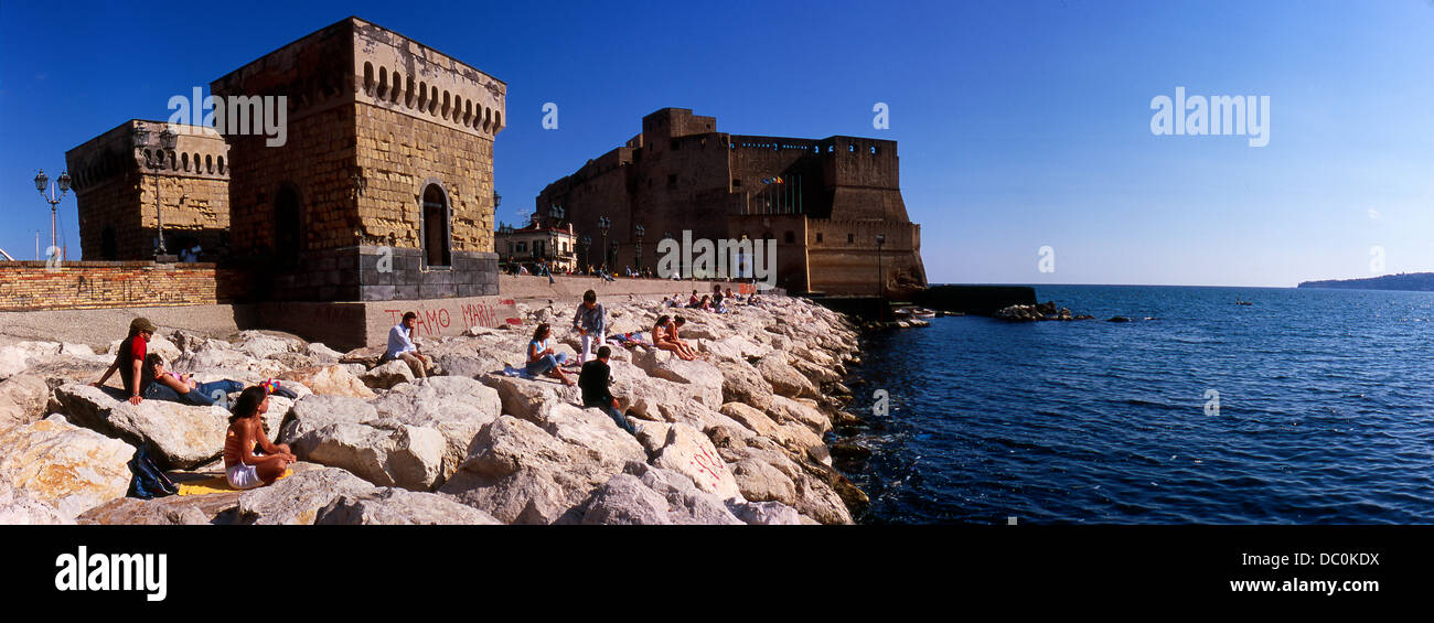 A group of Neapolitan sunbathing near the impressive Castle of the Egg ...