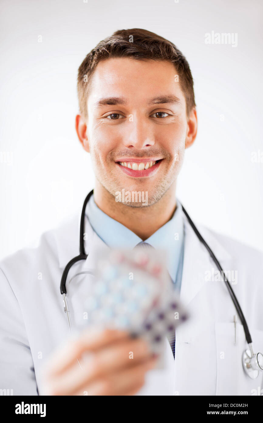 young male doctor with packs of pills Stock Photo - Alamy
