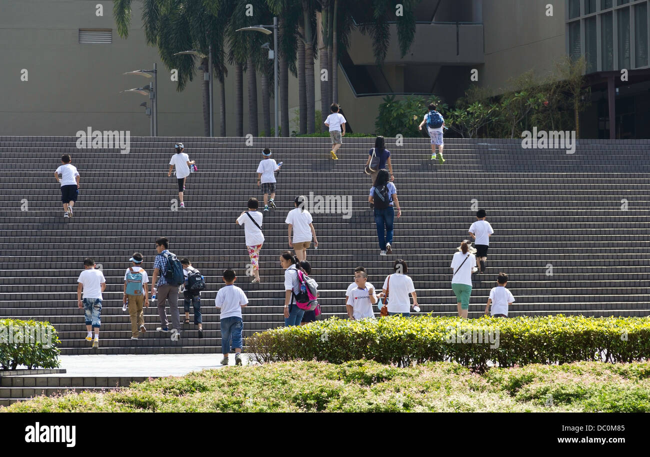 People climbing the steps in front of a building in Singapore. These ...