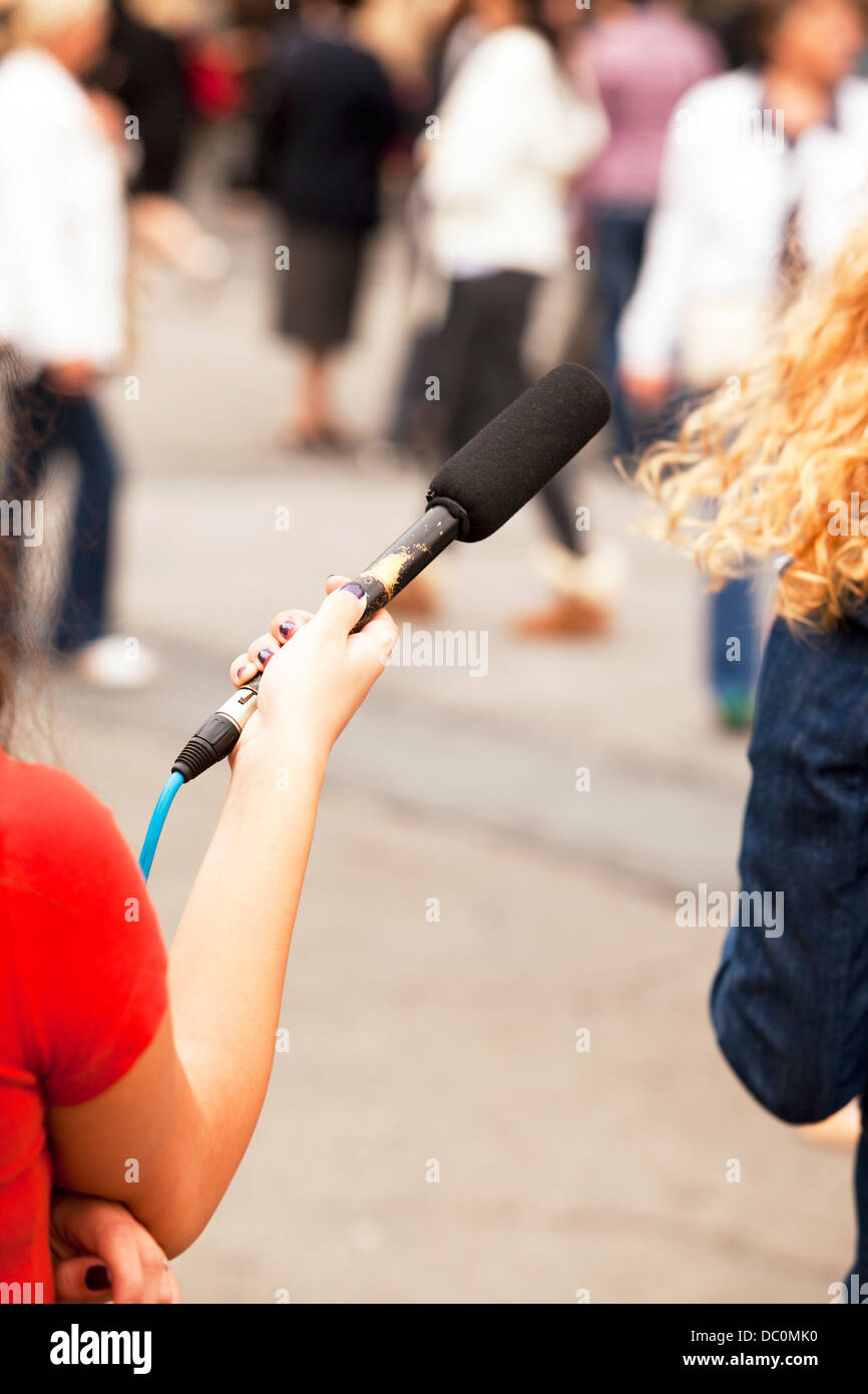A journalist is making a interview with a microphone Stock Photo - Alamy