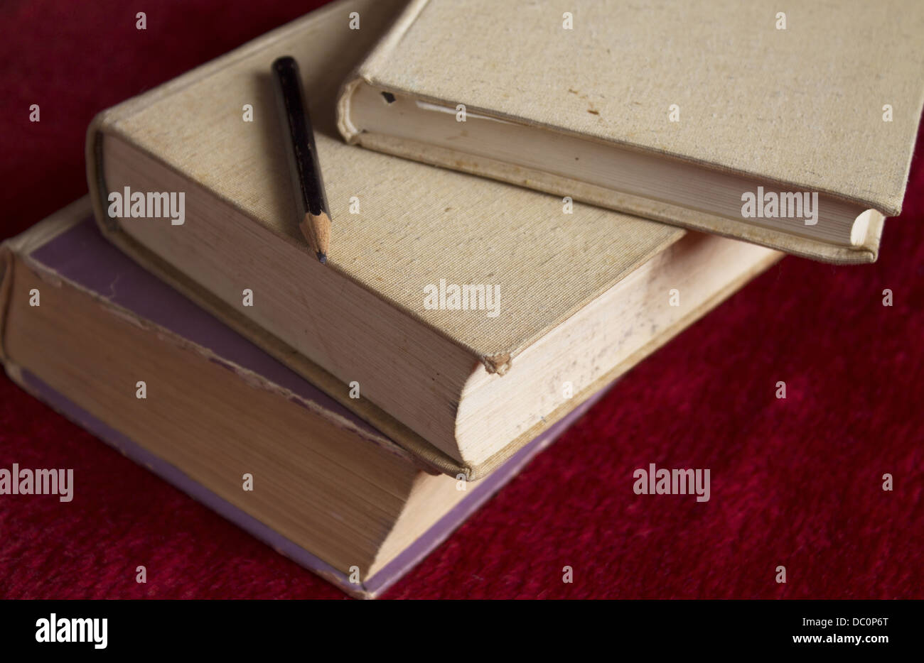 pencil and three books Stock Photo - Alamy