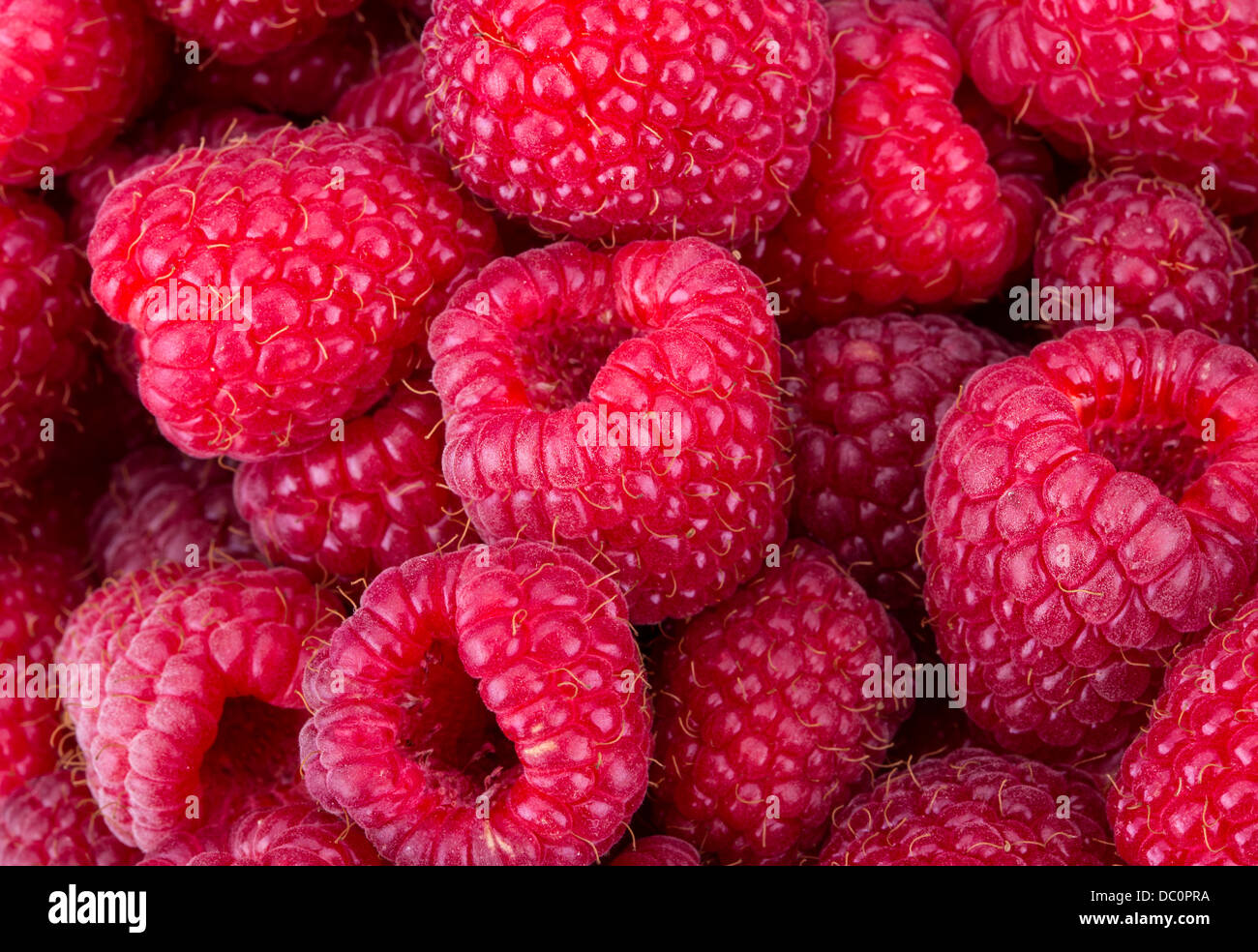 fresh red raspberries a tasty food background Stock Photo - Alamy
